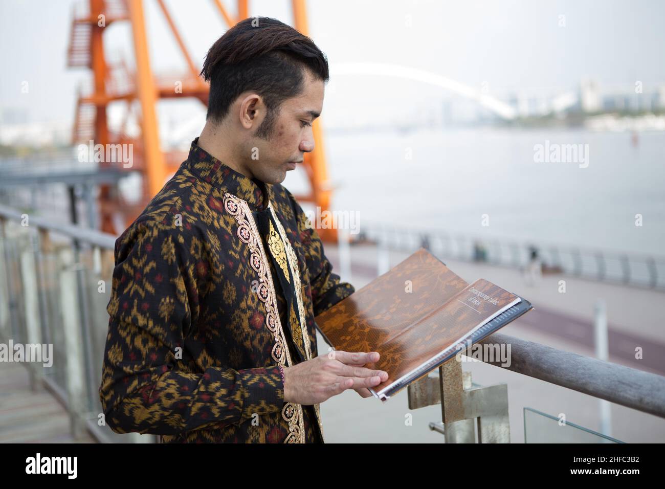 A young male model dressed in Indonesian Batik with Balinese Flower ...