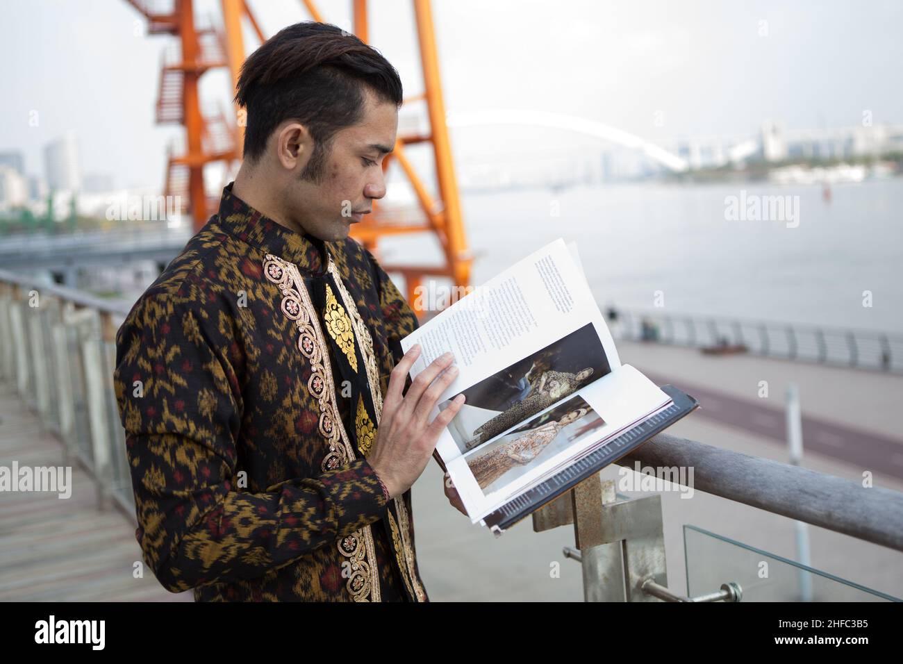 A young male model dressed in Indonesian Batik with Balinese Flower ...