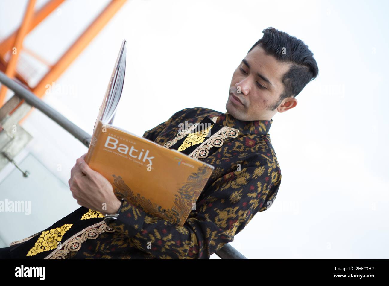 A young male model dressed in Indonesian Batik with Balinese Flower ...