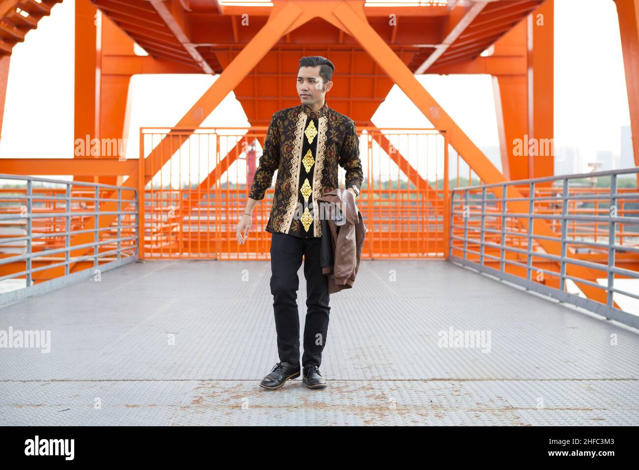A young male model dressed in Indonesian Batik with Balinese Flower ...