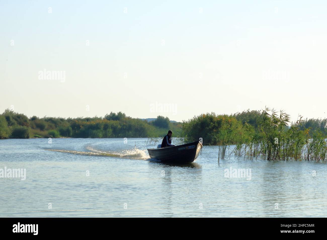 Danube Delta landscape with a fishing boat in Romania Stock Photo - Alamy