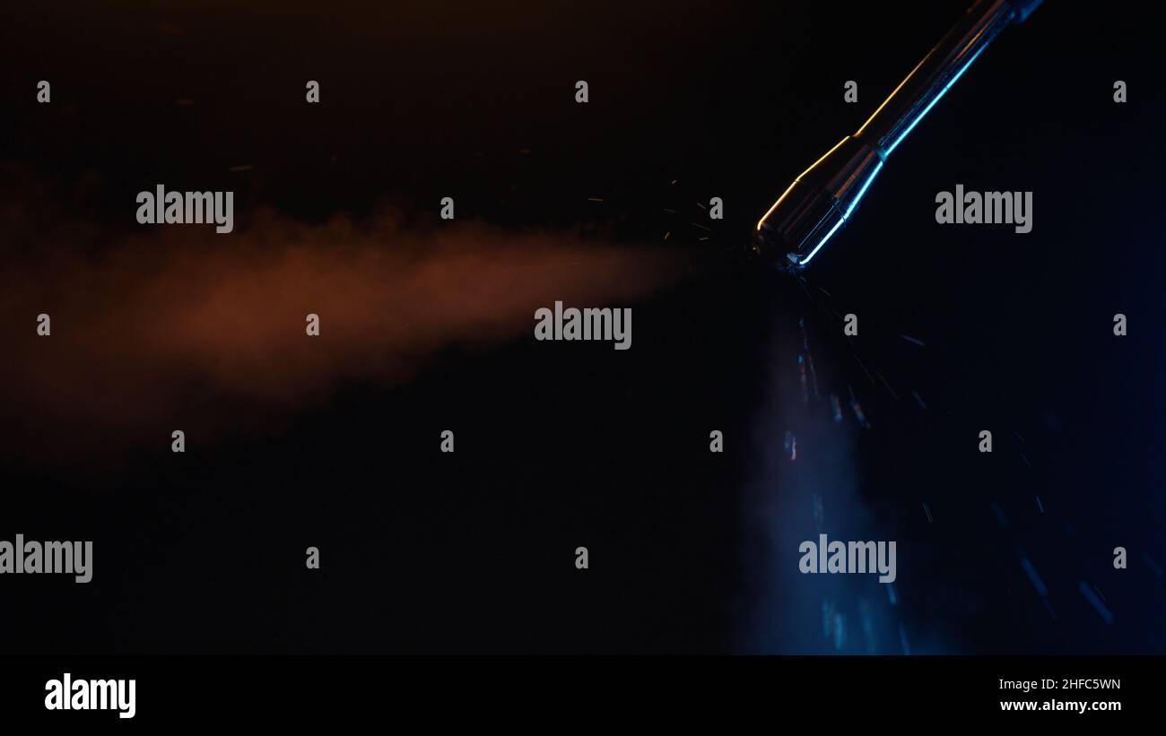 purging steam wand of coffee machine under neon lighting, wide photo ...