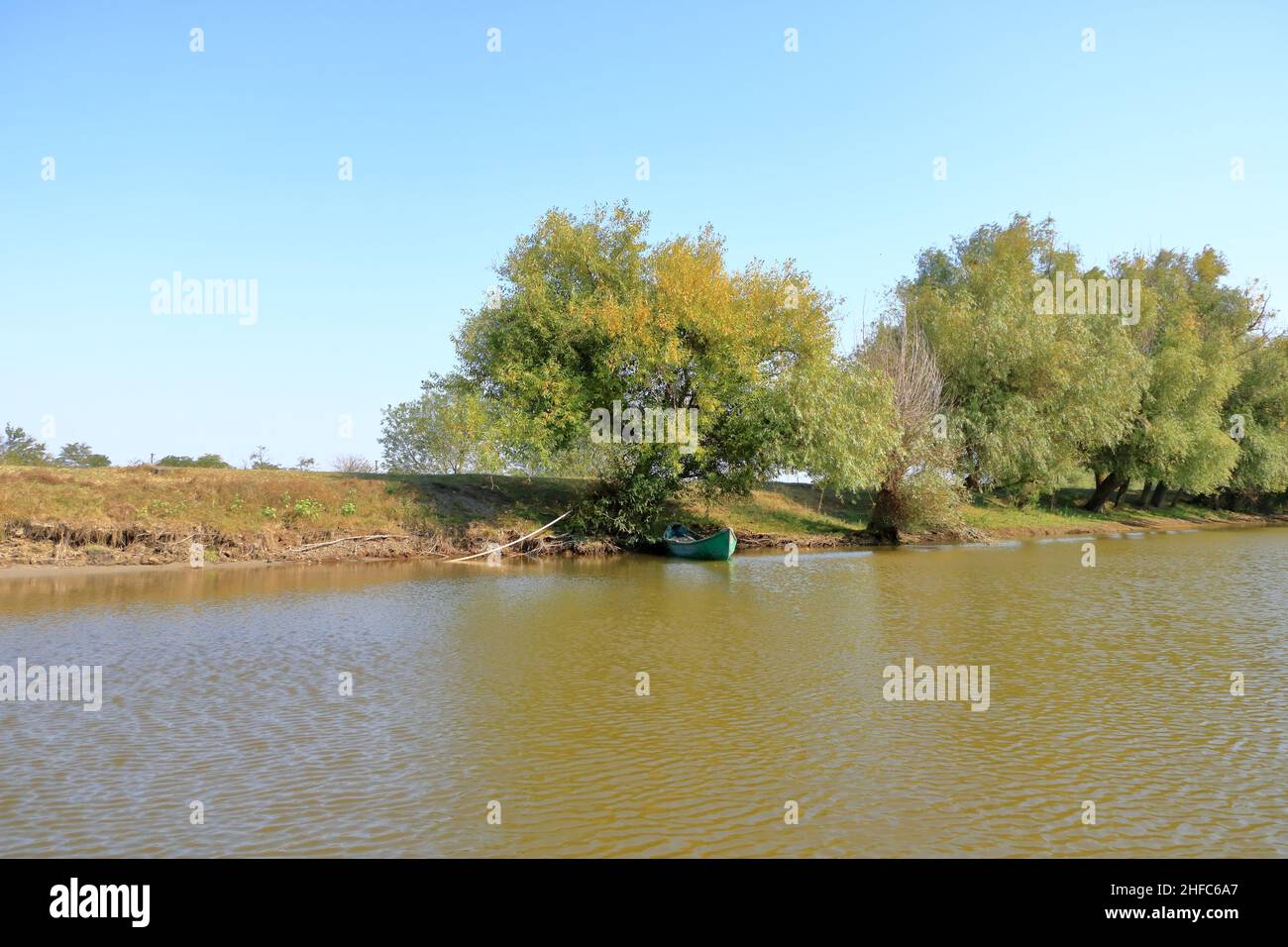 Danube Delta landscape with a fishing boat in Romania Stock Photo - Alamy