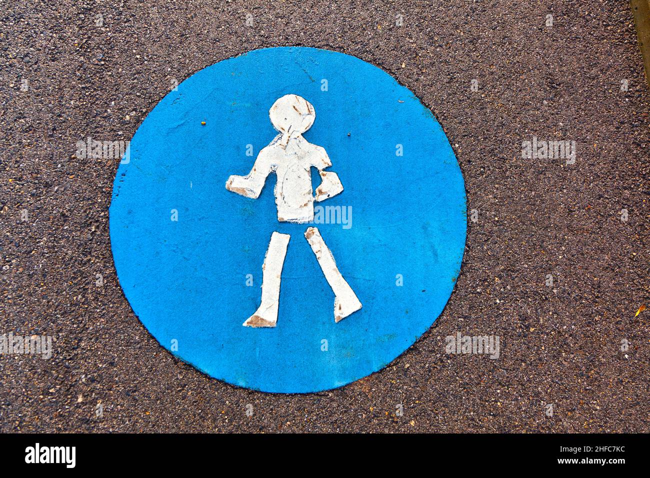symbol for pathway and icon for pedestrians on asphalt Stock Photo - Alamy