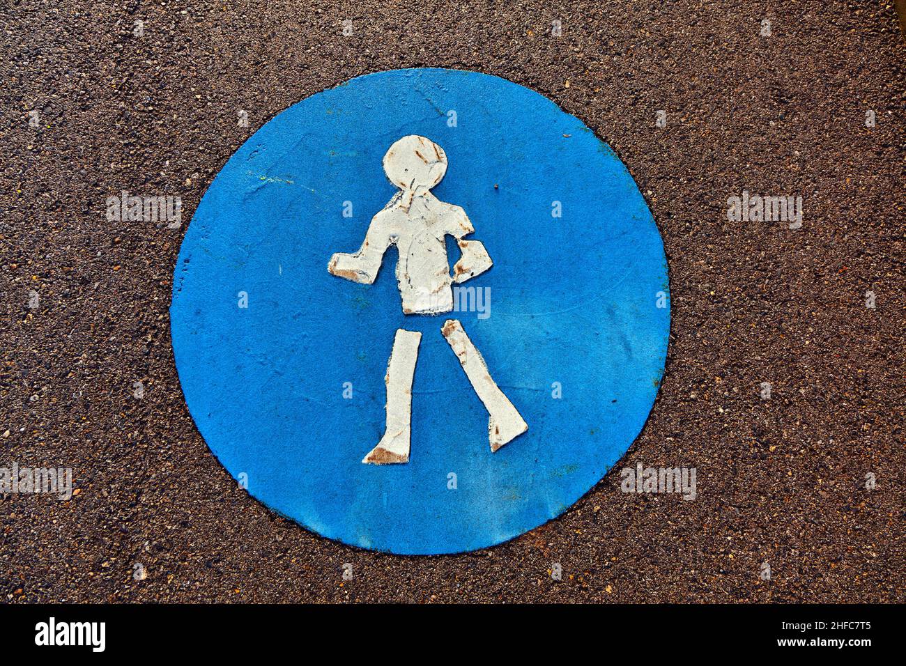 symbol for pathway and icon for pedestrians on asphalt Stock Photo - Alamy