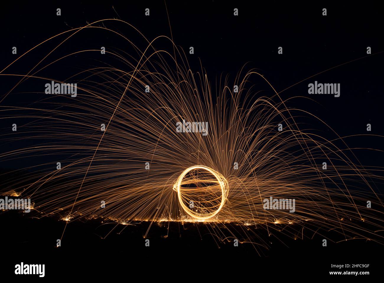Sparks of fire fly in the darkness Stock Photo - Alamy