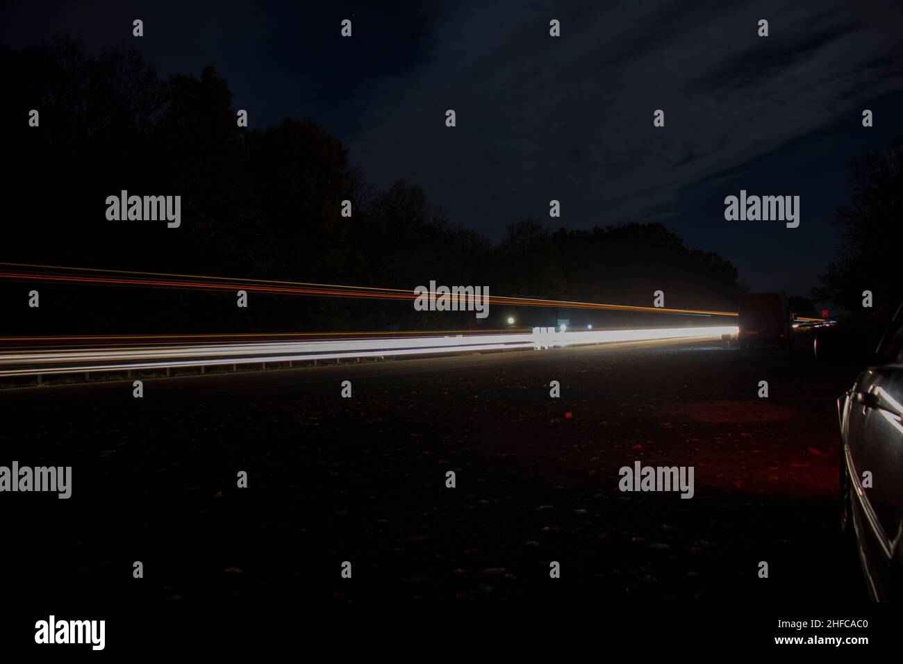 Lights from passing cars. Tracer Stock Photo - Alamy