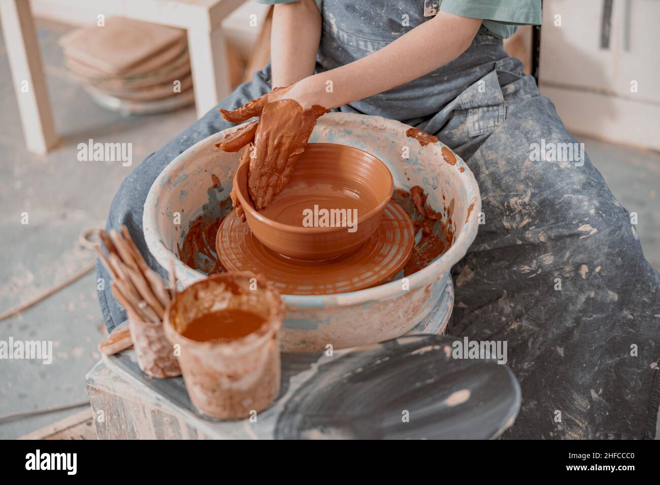 Young potter works in workshop hi-res stock photography and images - Alamy