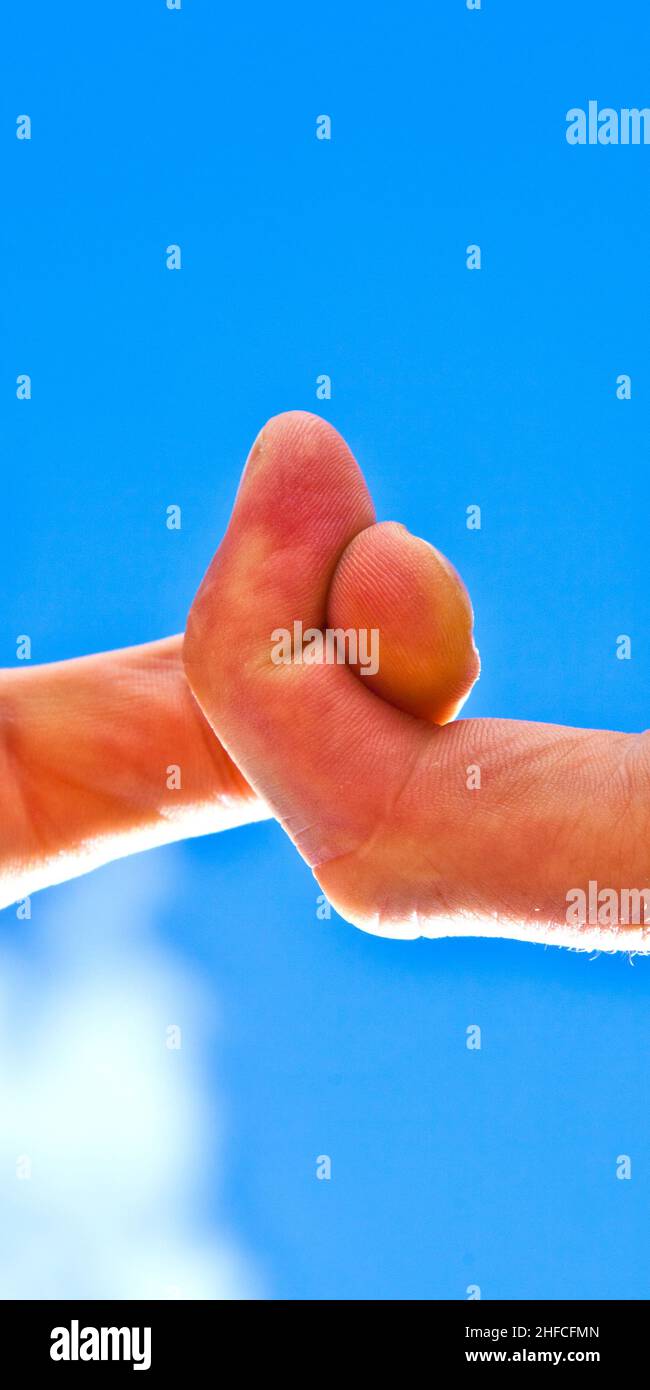 two fingers are connected with blue sky Stock Photo - Alamy
