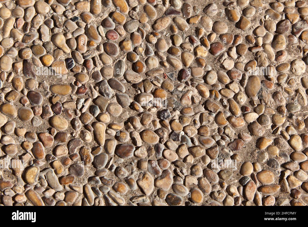 pattern of stones in concrete Stock Photo - Alamy