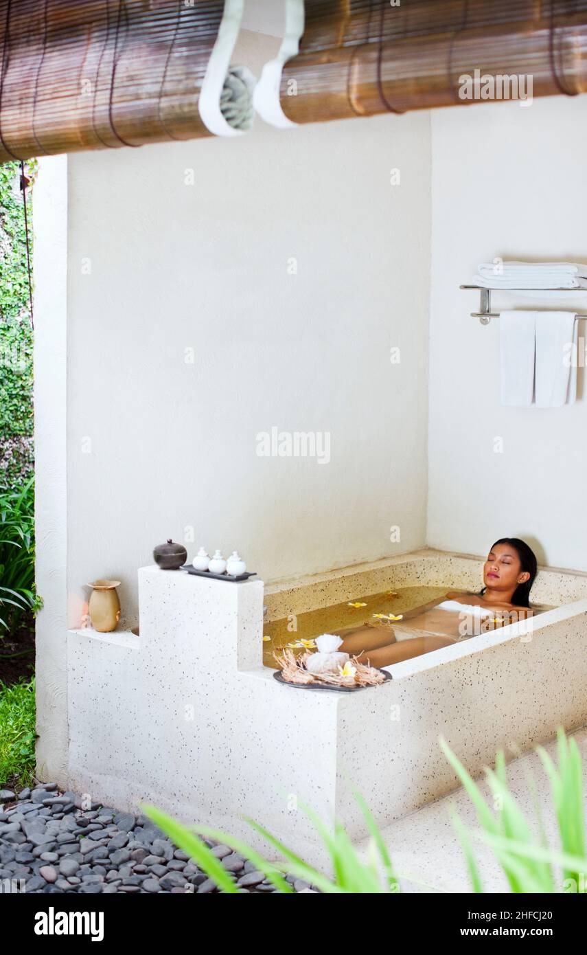 Woman relaxes floral bath at Rebab Spa, Kayumanis Gangsa, Bali ...
