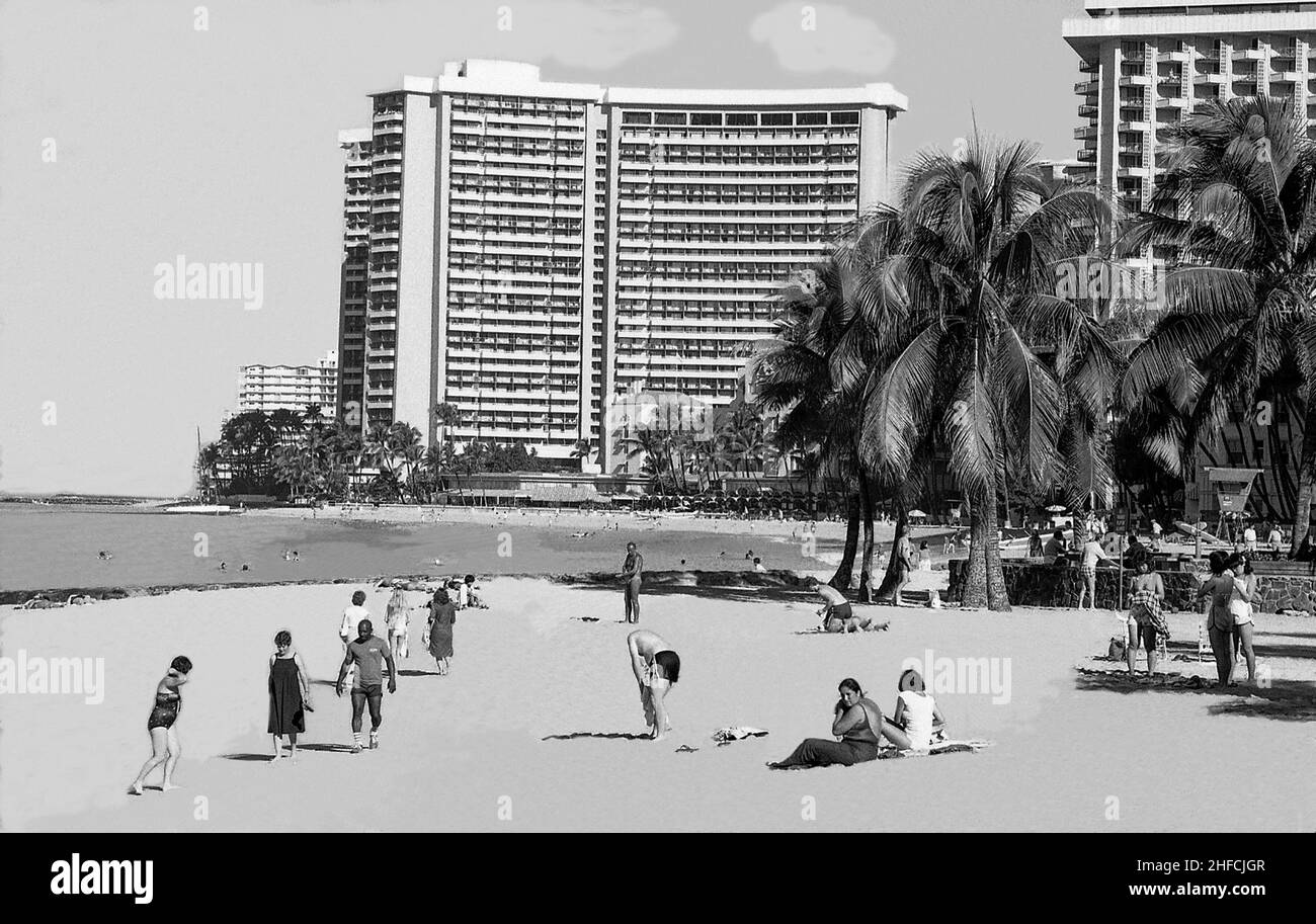 HAWAII HONOLULU Sunbathing people on the beach below luxury hotels ...