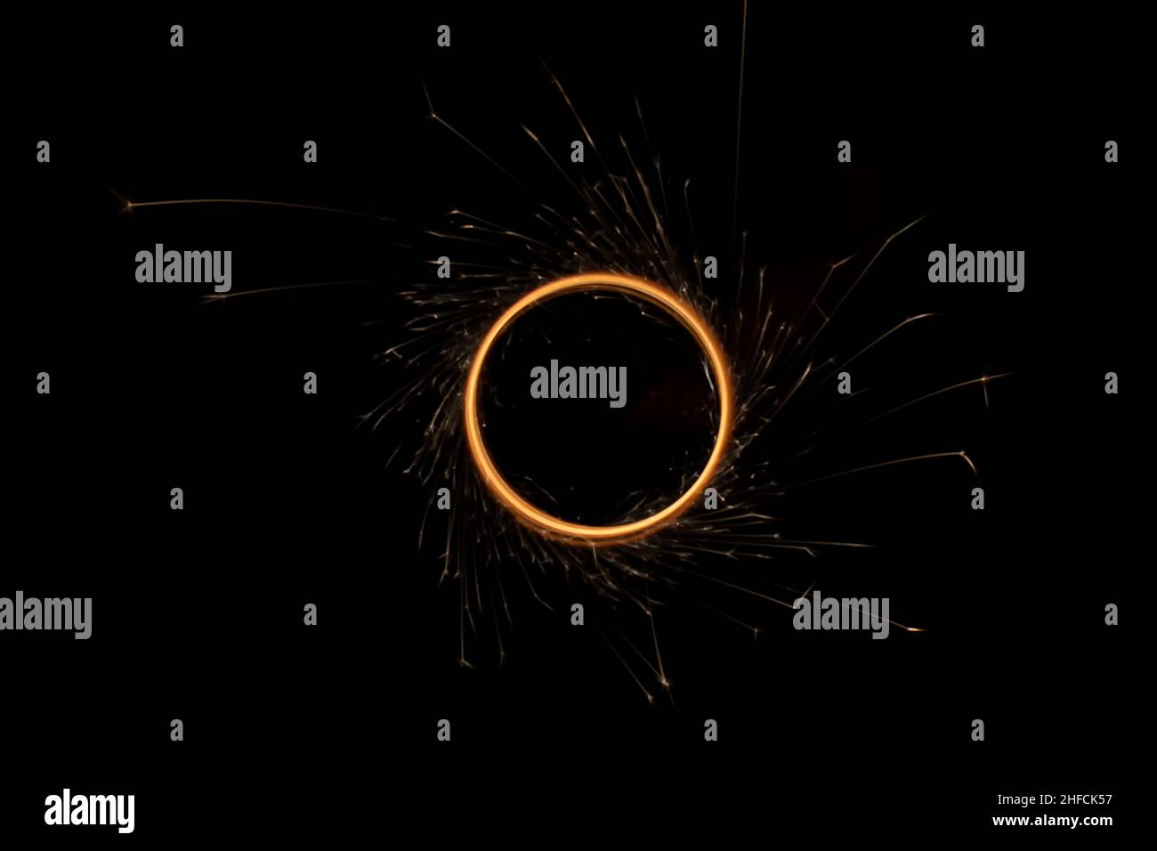 Circular lights with sparks on a black background Stock Photo - Alamy