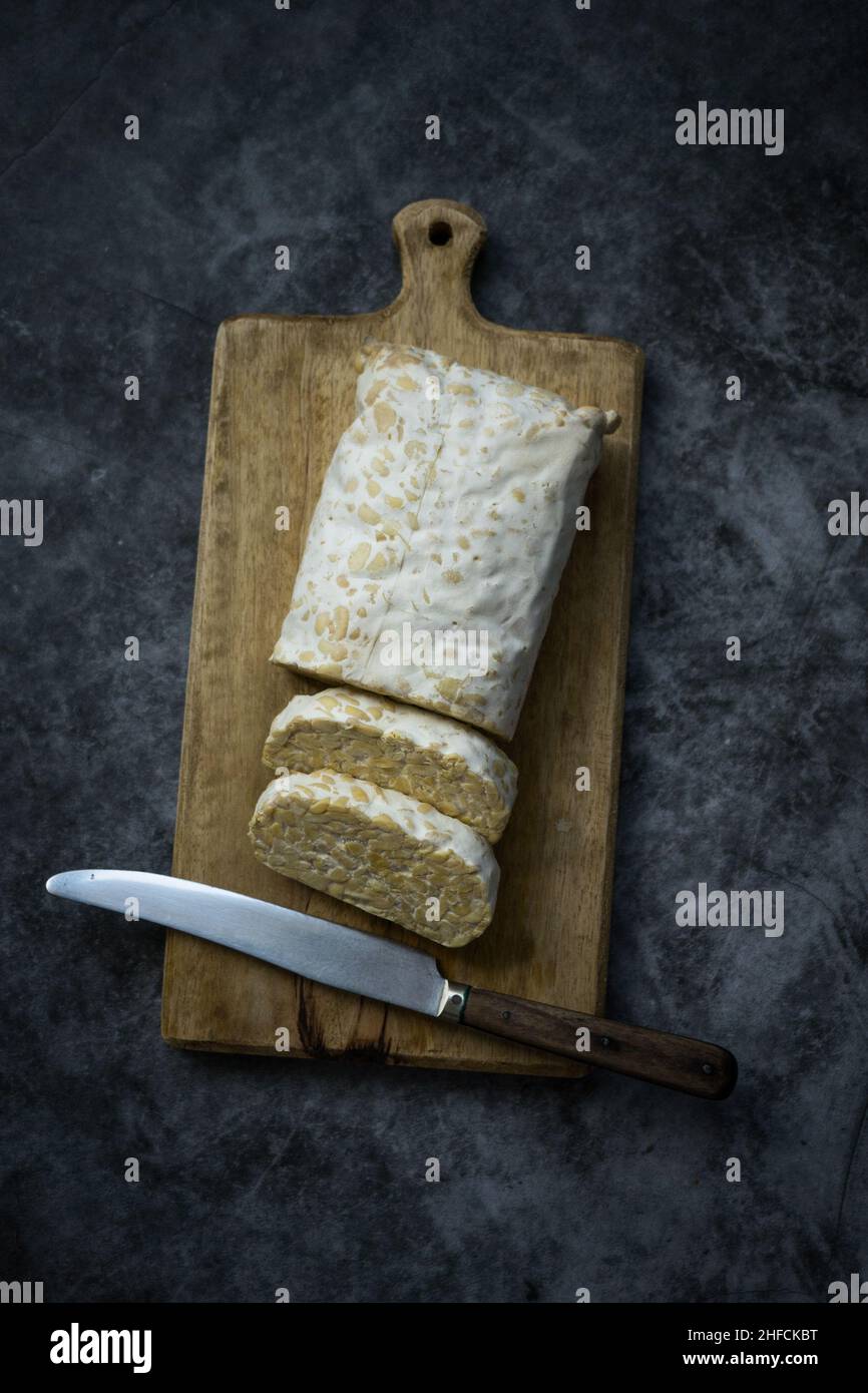 Sliced fresh raw tempeh on cutting board, Tempeh is very famous ... Sliced fresh raw tempeh on cutting board, Tempeh is very famous ...