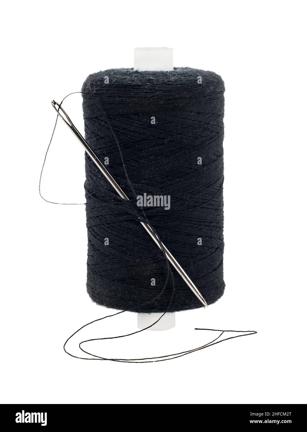 Needle with black threads isolate. Spool of thread close-up on a white ...