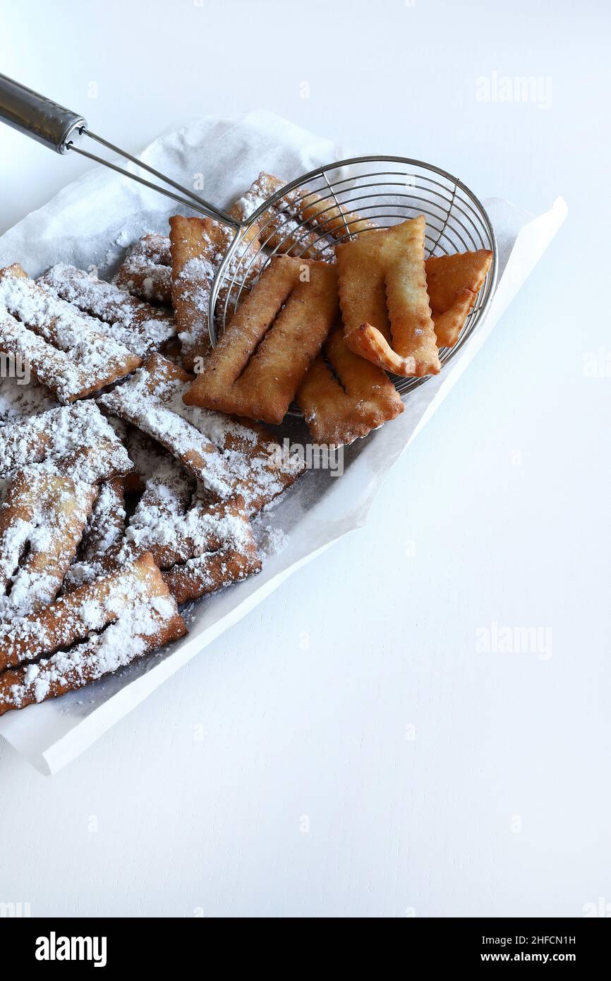 Homemade traditional Italian carnival sweets: chiacchiere on white ...