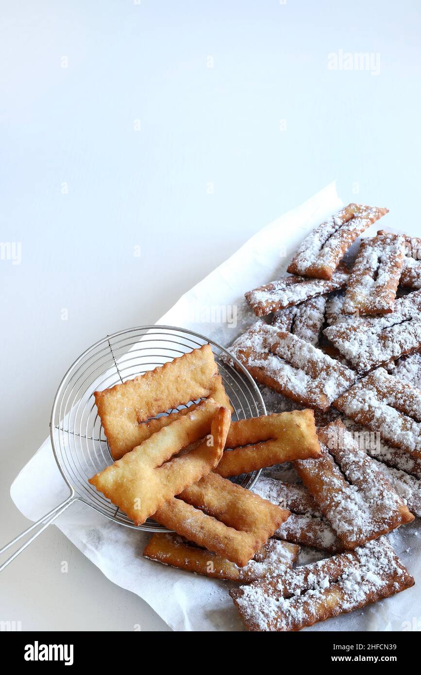 Homemade traditional Italian carnival sweets: chiacchiere on white ...