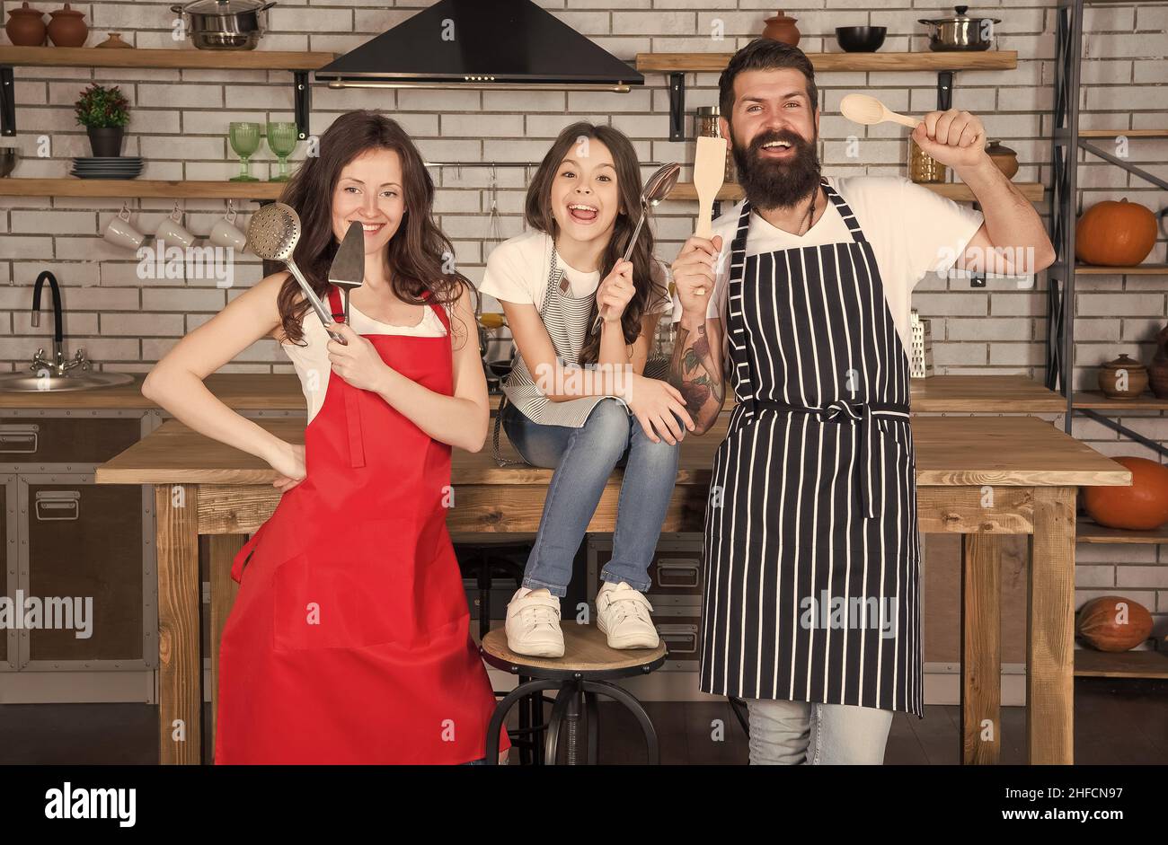 Parents mom dad and daughter cooking food together, cook with love ...