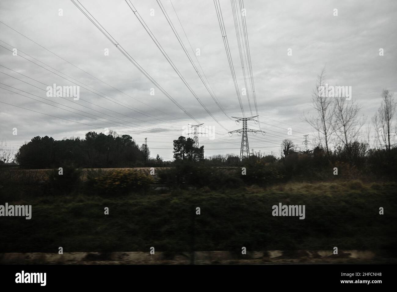 This photo shows high voltage lines, erected in the middle of farmland ...