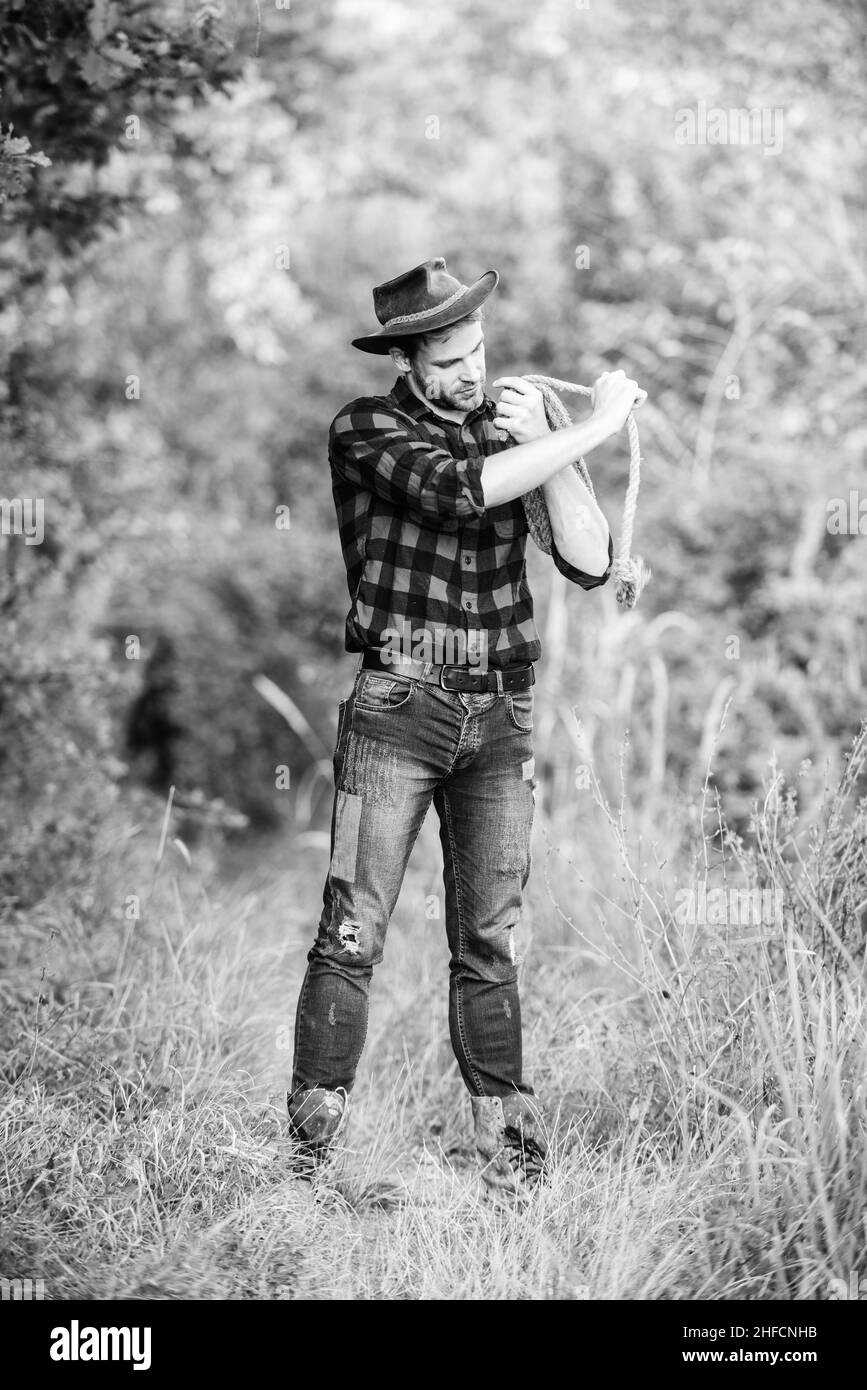 Man wearing hat hold rope. Ranch occupations. Lasso tool. American ...