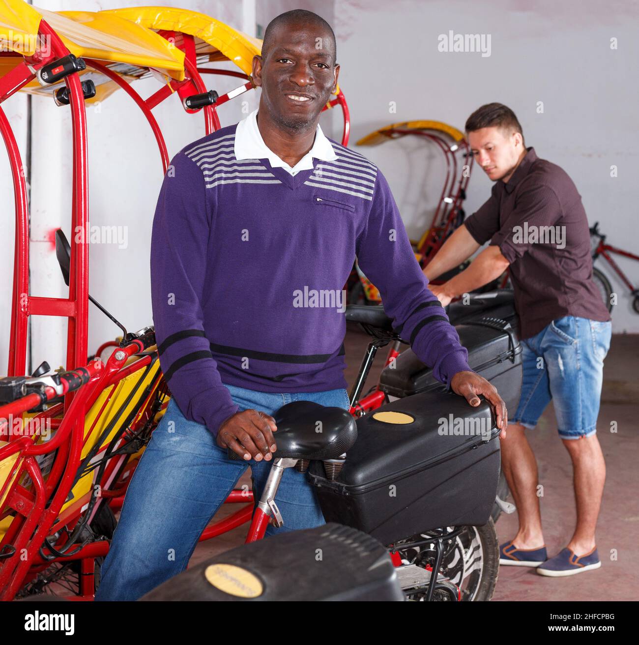 African-American man offering cycle rickshaw service Stock Photo - Alamy