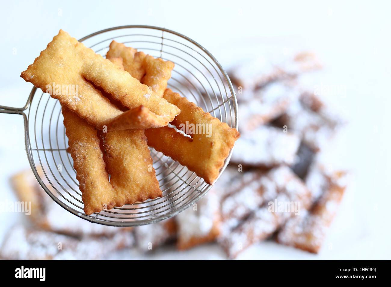 Homemade traditional Italian carnival sweets: chiacchiere on white ...