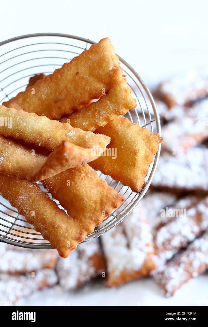 Homemade traditional Italian carnival sweets: chiacchiere on white ...