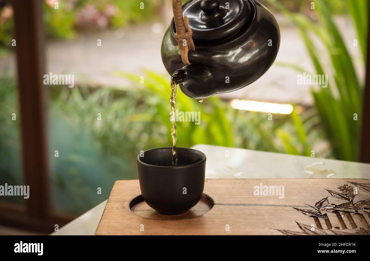 hand pour Chinese or Japanese traditional tea from clay pot Stock Photo ...