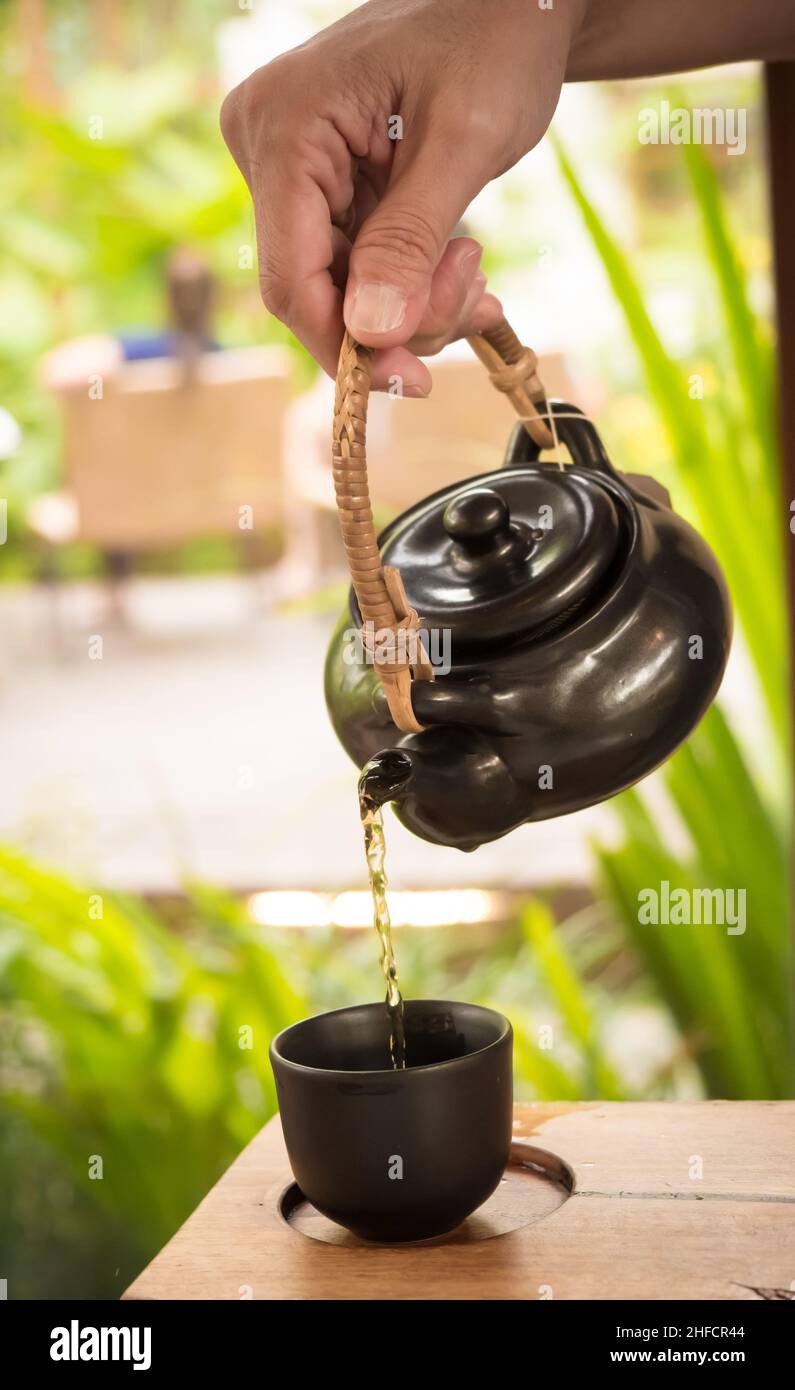 hand pour Chinese or Japanese traditional tea from clay pot Stock Photo ...