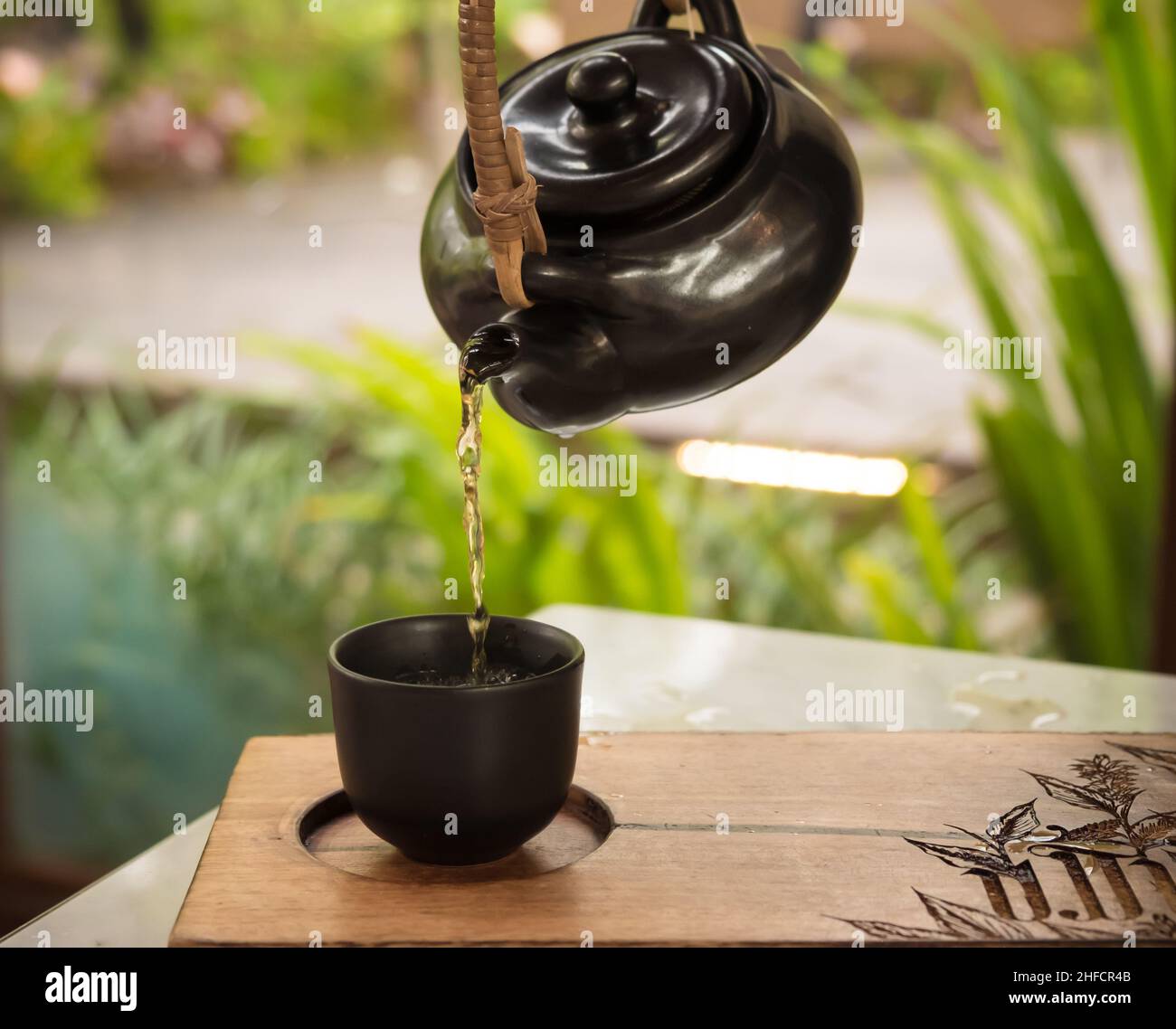 hand pour Chinese or Japanese traditional tea from clay pot Stock Photo ...