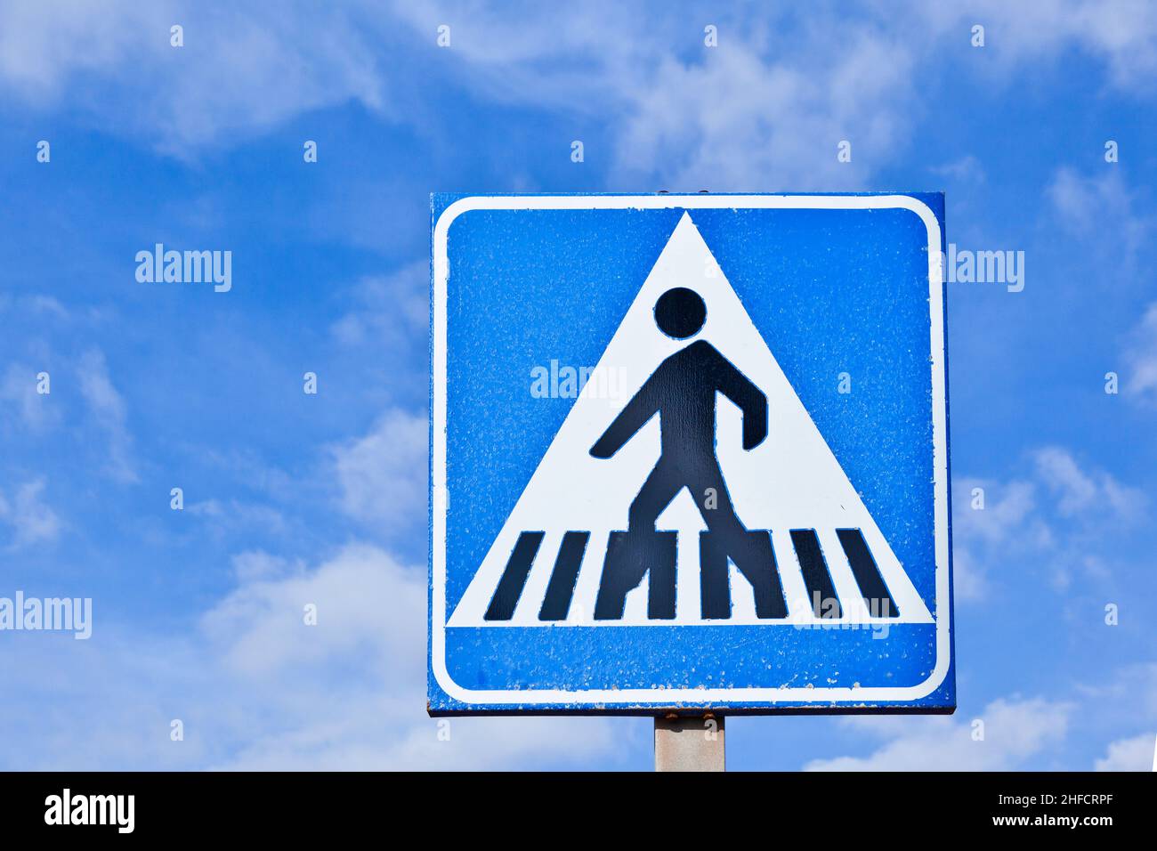 pedestrian crossing sign with blue sky Stock Photo - Alamy