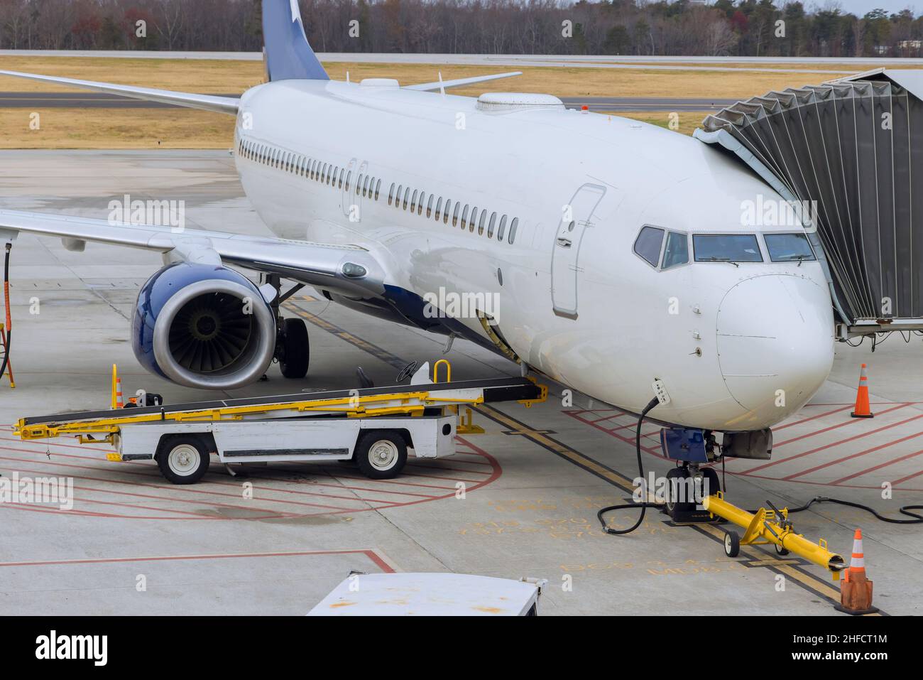 Preparation before flight with loading of cargo containers to airplane ...