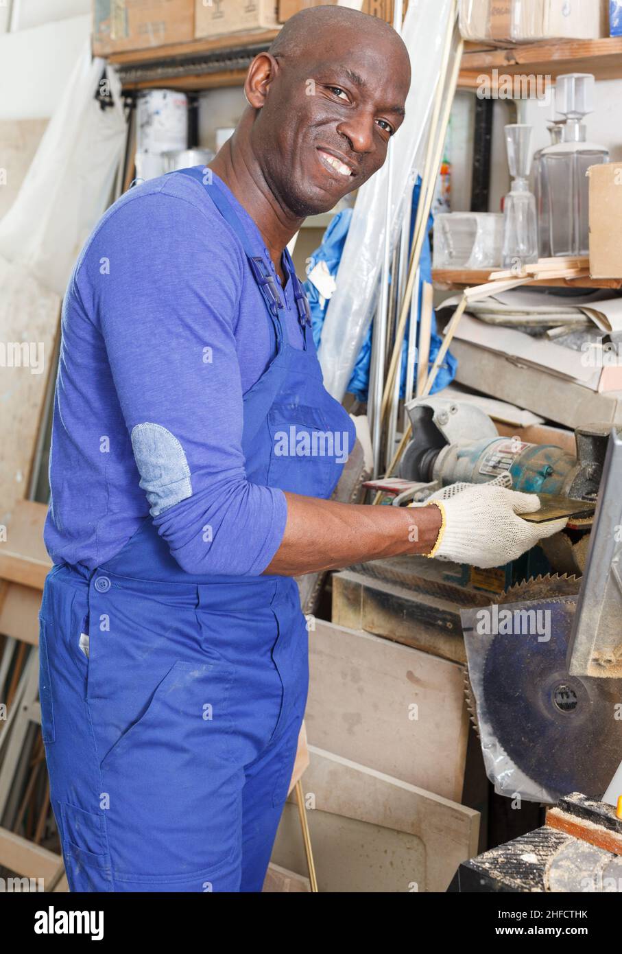 Glazier working on glass edge polishing machine Stock Photo - Alamy