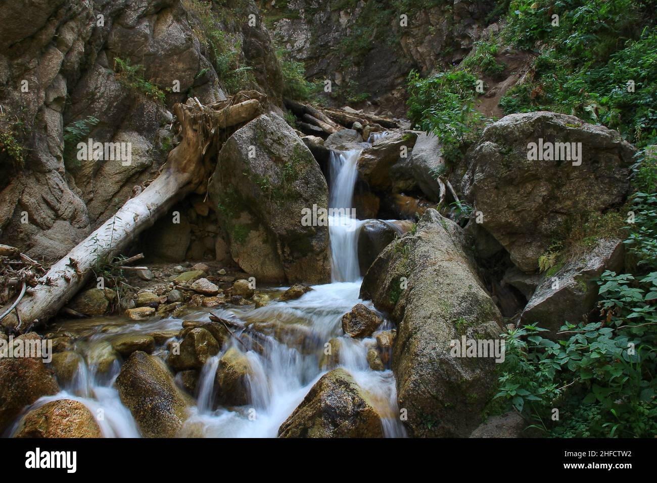 A small waterfall among the rocks in the Monk`s mountain gorge in ...