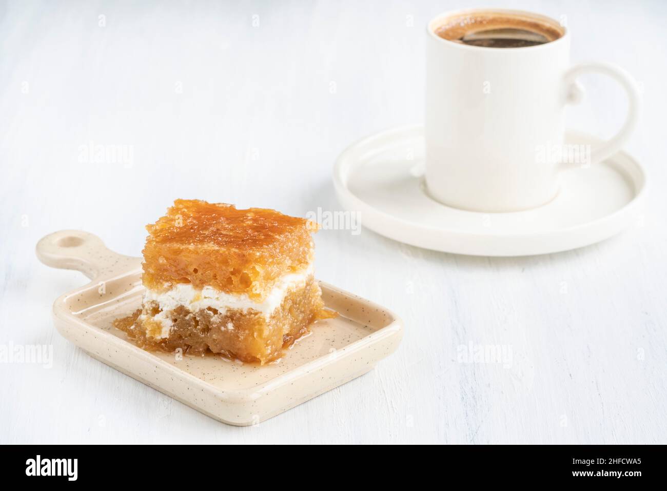 cup of Turkish coffee and traditional dessert with cream known as ...