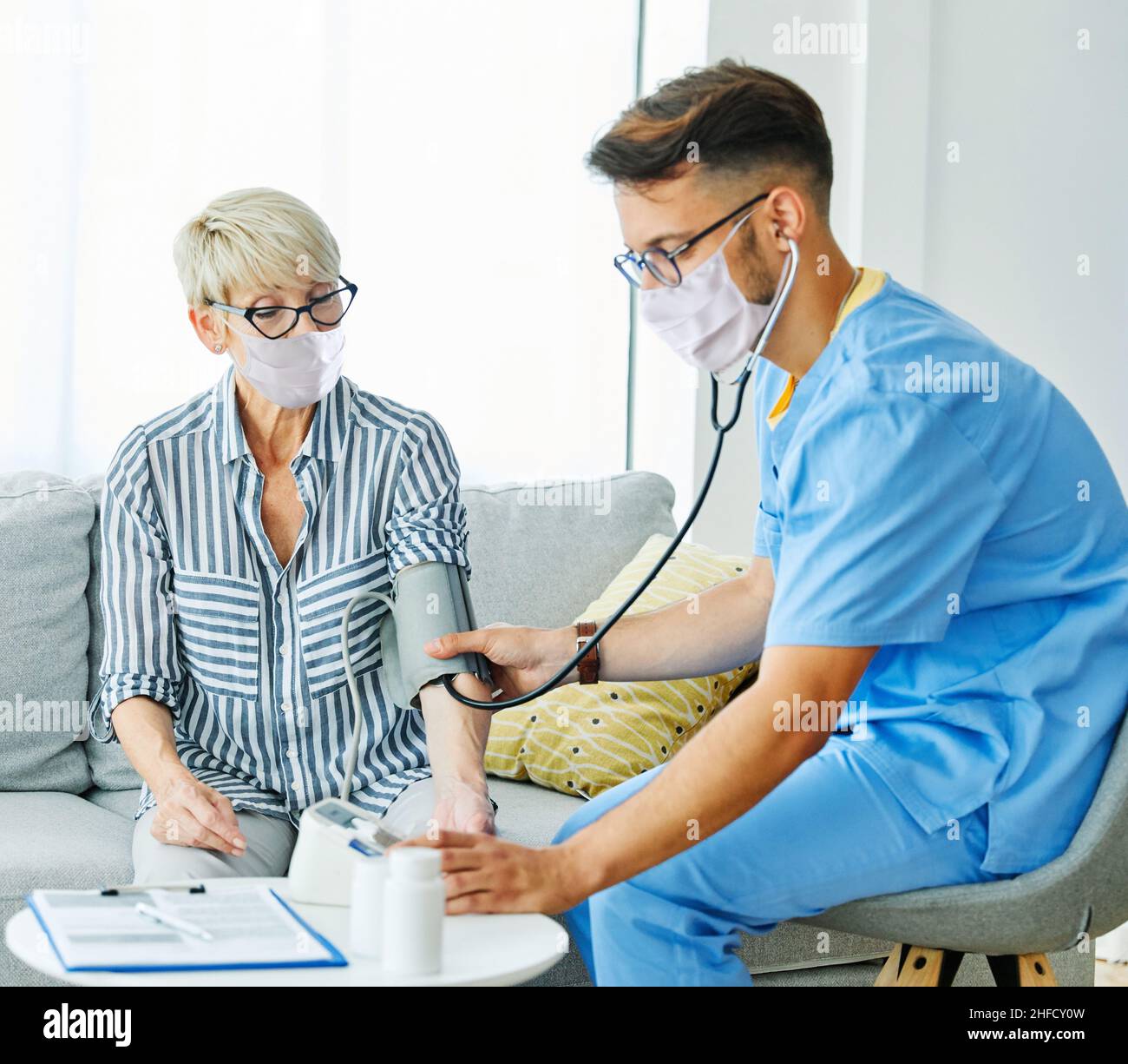 nurse doctor senior care caregiver help check exam blood pressure check ...