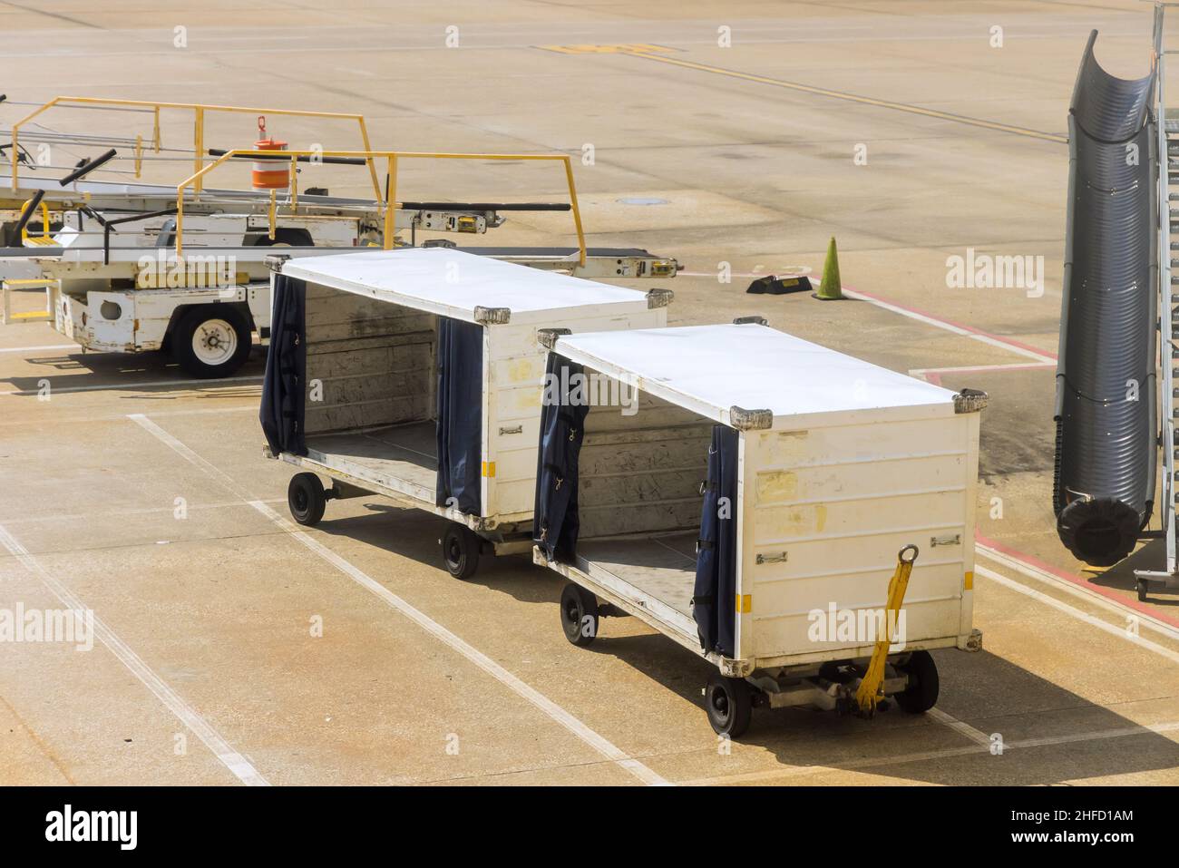 Freight trolleys on the runway of cargo to the commercial airplane ...