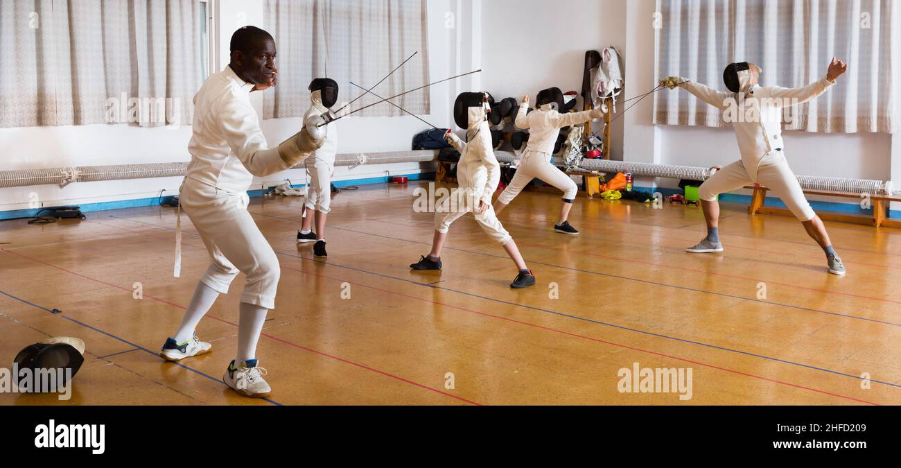 African American wearing fencing uniform practicing with foil Stock ...