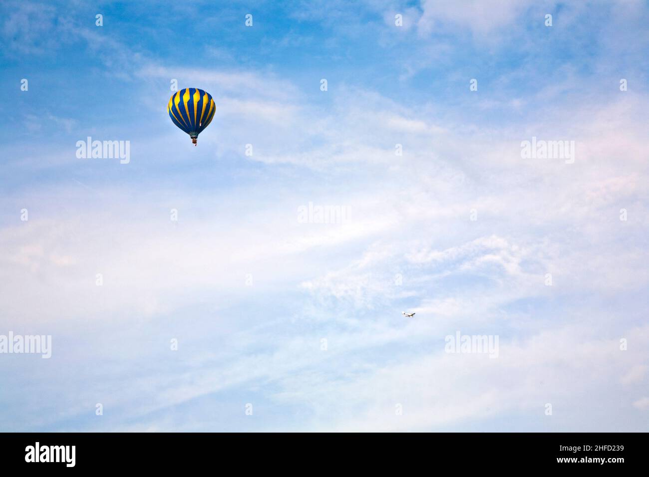 Hot Air Balloon in cloudy sky with Airplane Aircraft in lower level ...