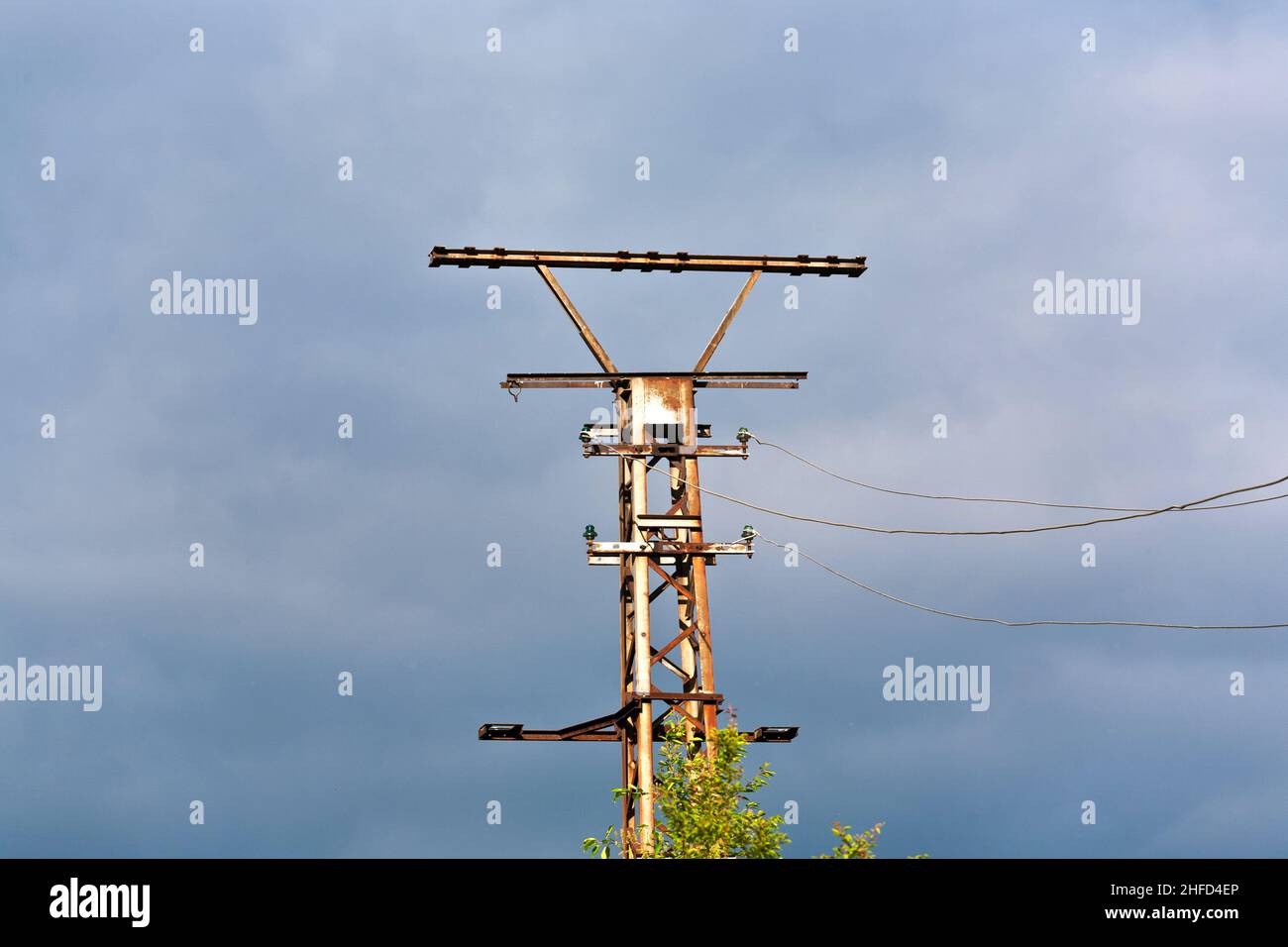 old rusty electrical tower with dark clouds Stock Photo - Alamy
