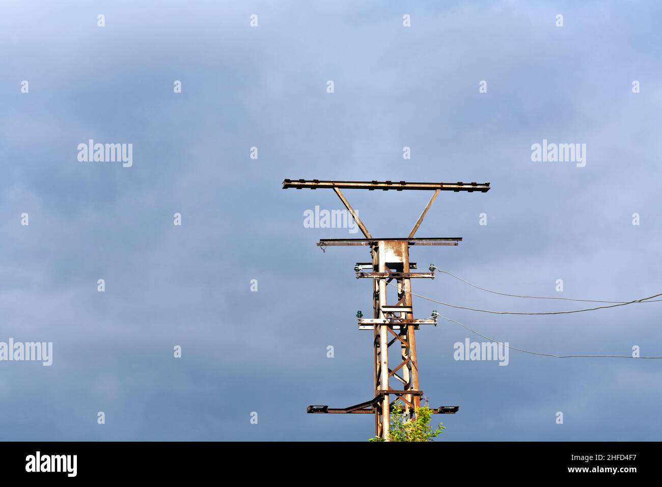 old rusty electrical tower with dark clouds Stock Photo - Alamy