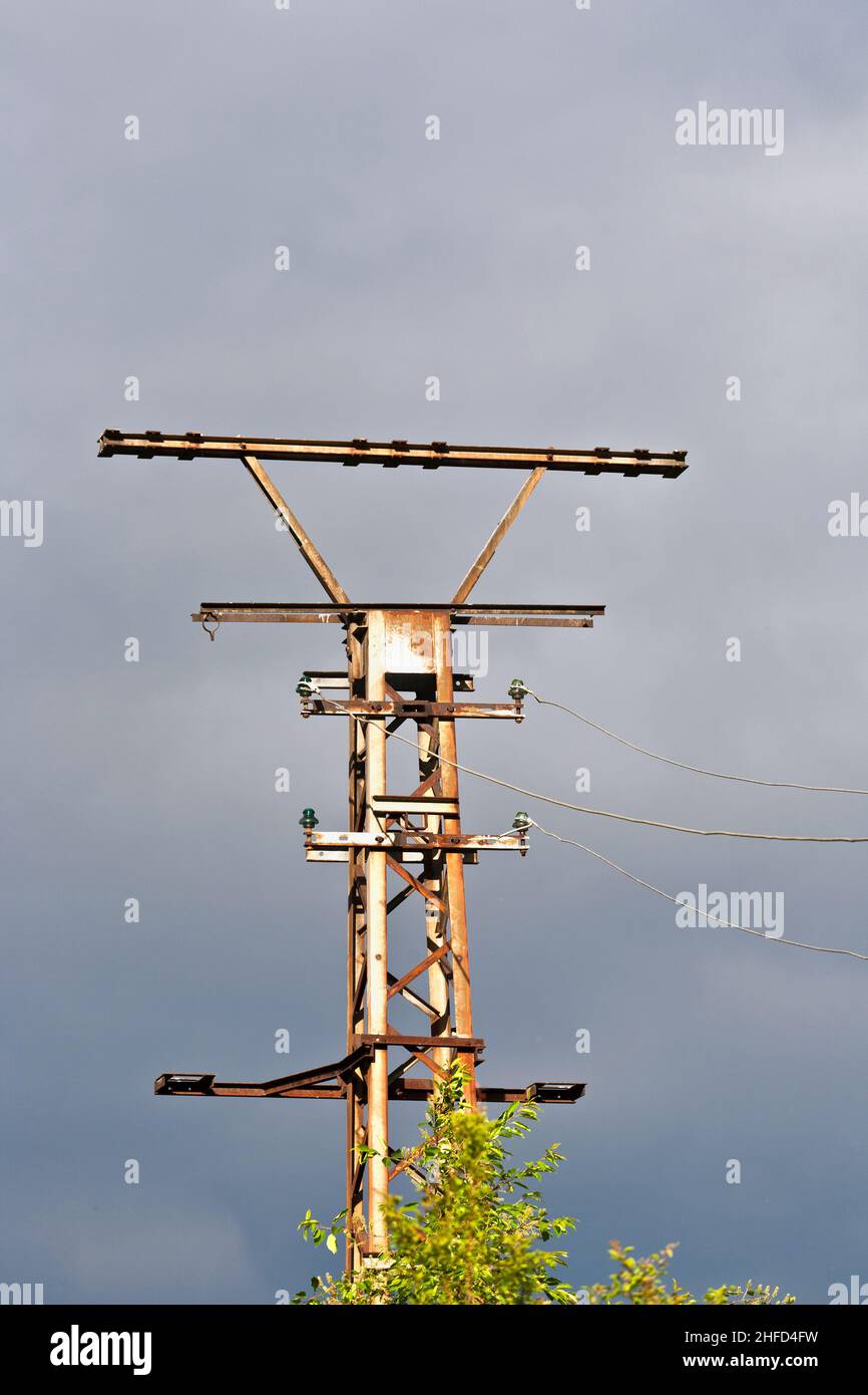 old rusty electrical tower with dark clouds Stock Photo - Alamy