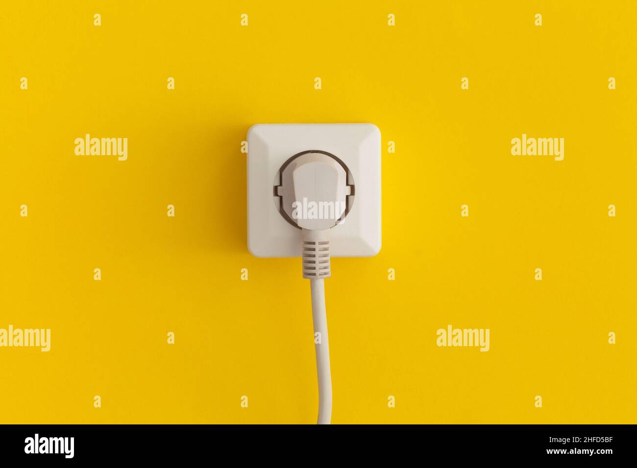 White plastic power socket on a yellow background Stock Photo - Alamy