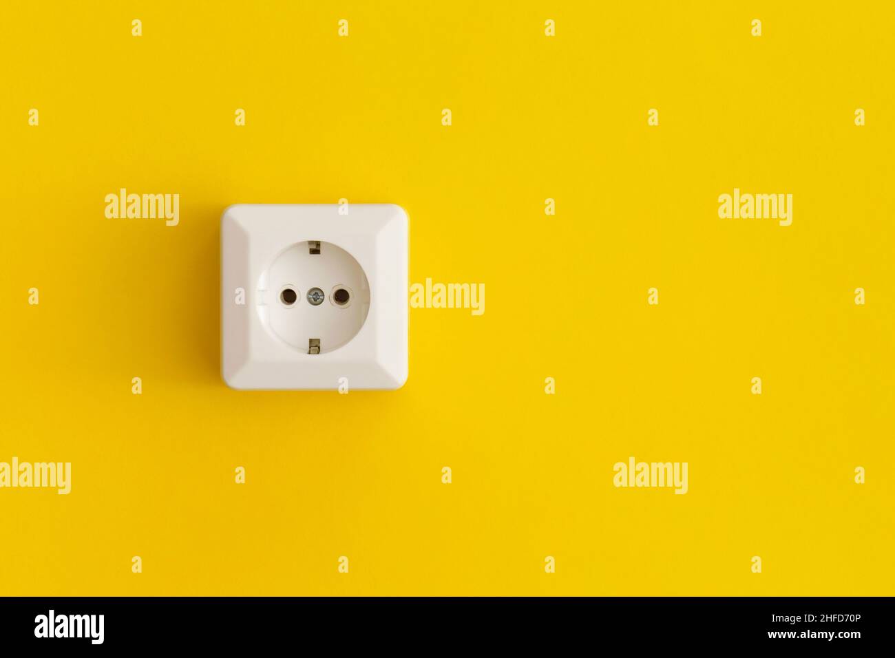 White plastic power socket on a yellow background Stock Photo - Alamy