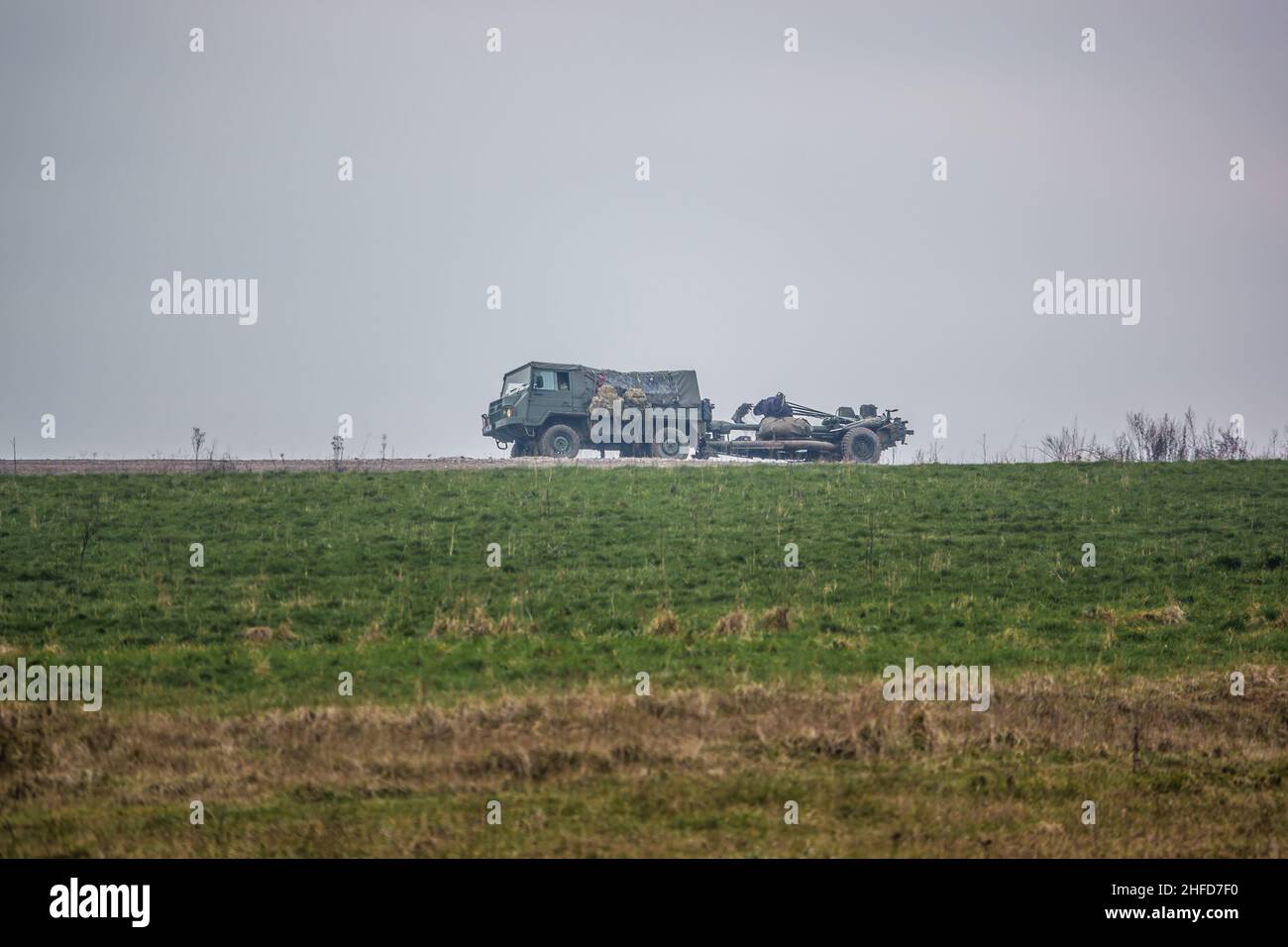 British army Pinzgauer High-Mobility All-Terrain 4x4 vehicle towing a ...