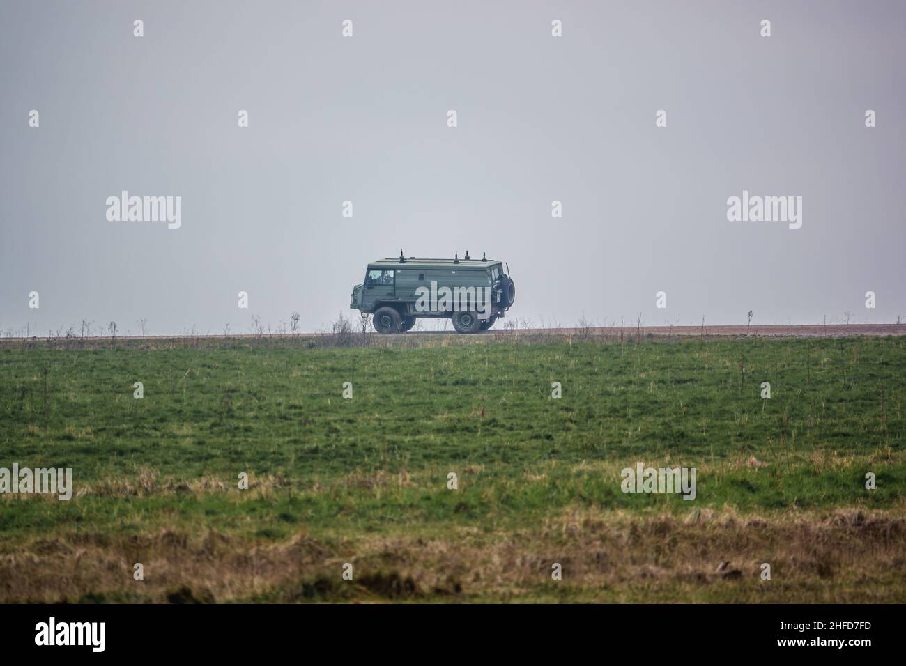 British army Pinzgauer High-Mobility All-Terrain 4x4 vehicle towing a ...