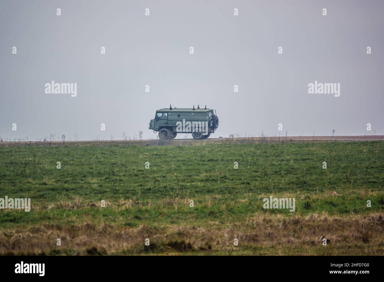 British army Pinzgauer High-Mobility All-Terrain 4x4 vehicle towing a ...