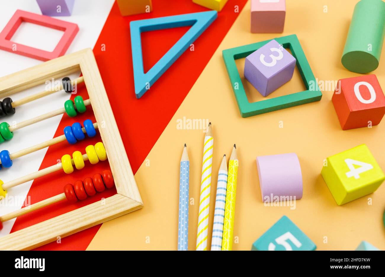 Multicolored wooden blocks on red background. Trendy puzzle toys ...