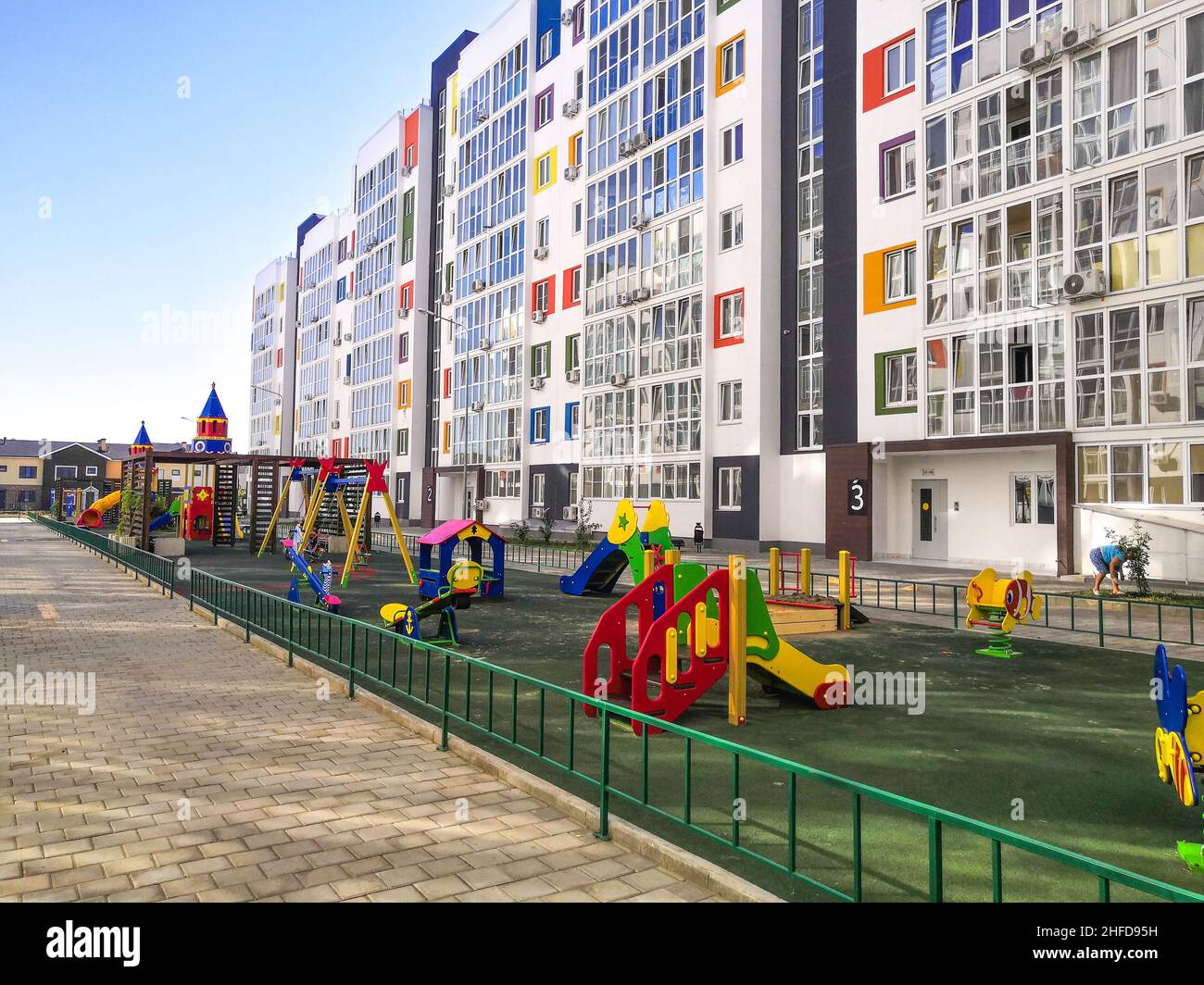 A modern courtyard of a residential high-rise building with a colorful ...