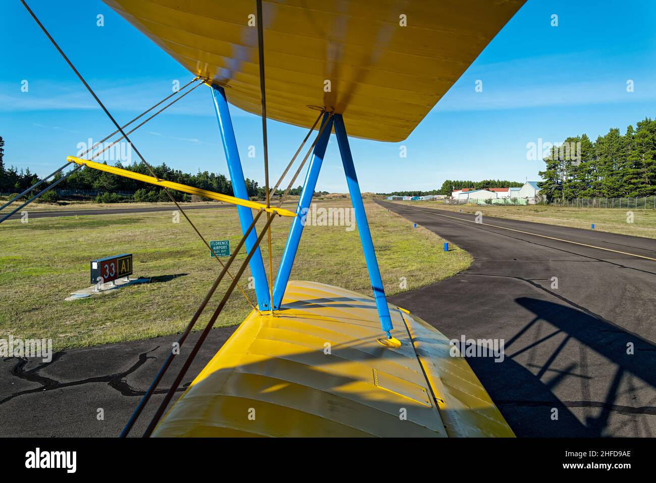 Runway viewed through the wings of a biplane at the airport in Florence ...